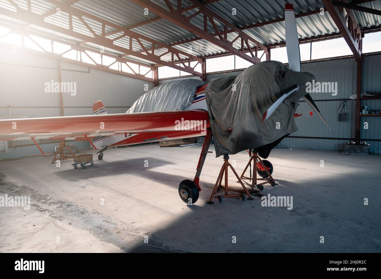 Small private lightweight propeller airplanes in hangar Stock Photo - Alamy