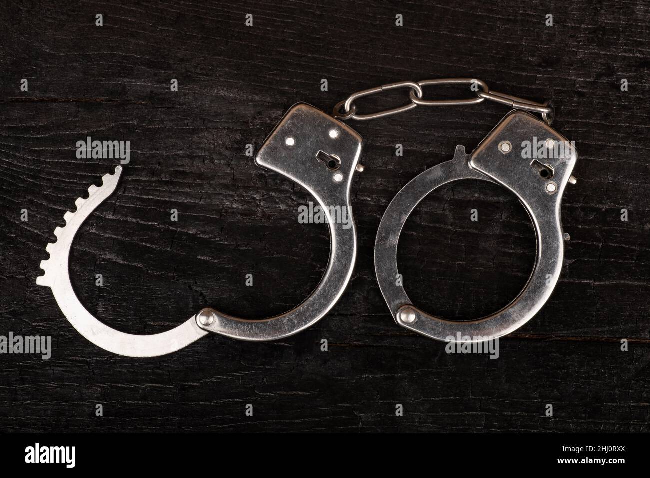 open handcuffs closeup punishment for a crime Stock Photo - Alamy