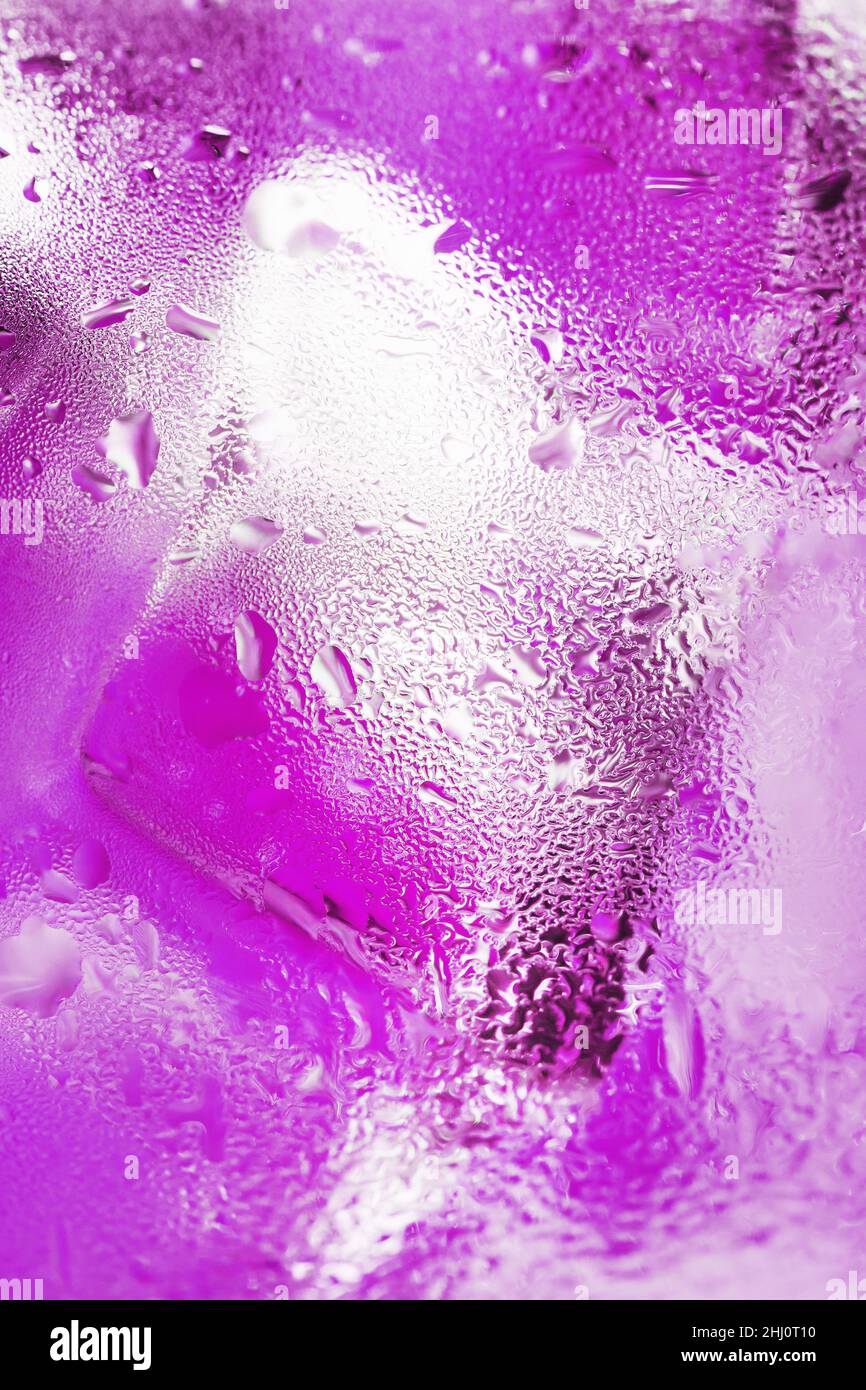 Ice cubes in a misted glass with drops of ice water close-up macro. Refreshing and chilling ...