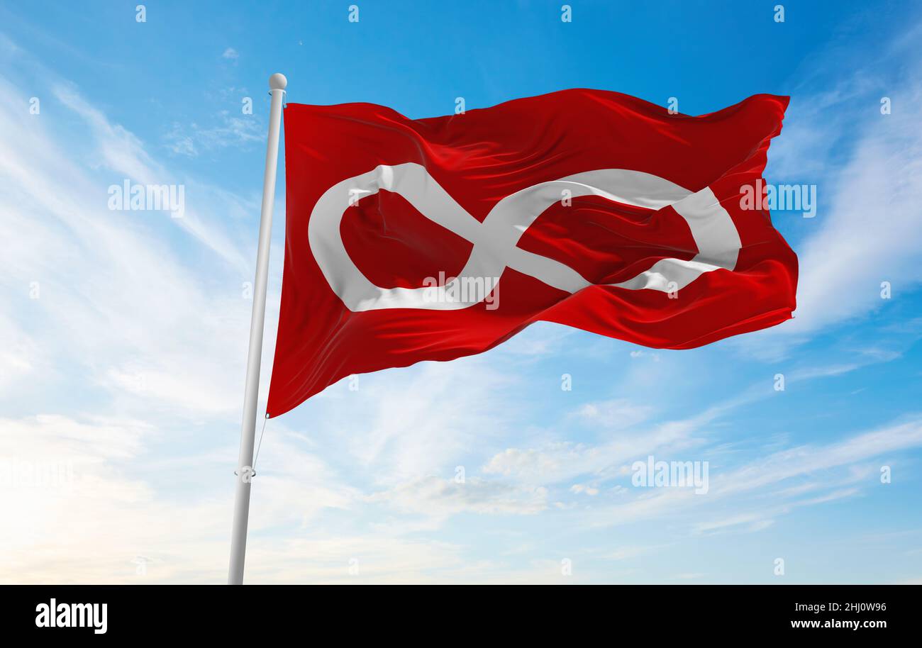 flag of Metis Red , Canada at cloudy sky background on sunset ...