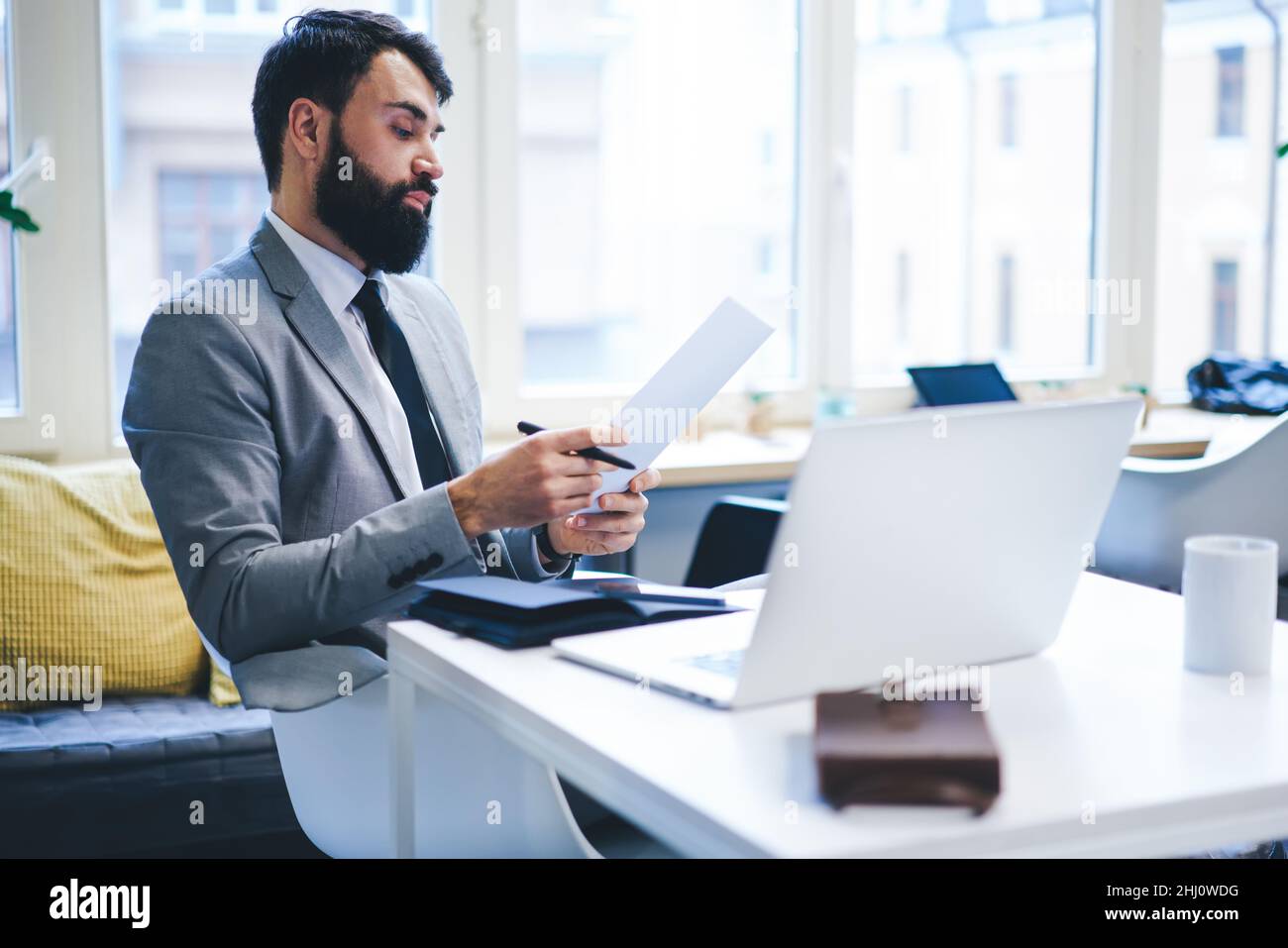 Serious businessman looking through documents hi-res stock photography ...