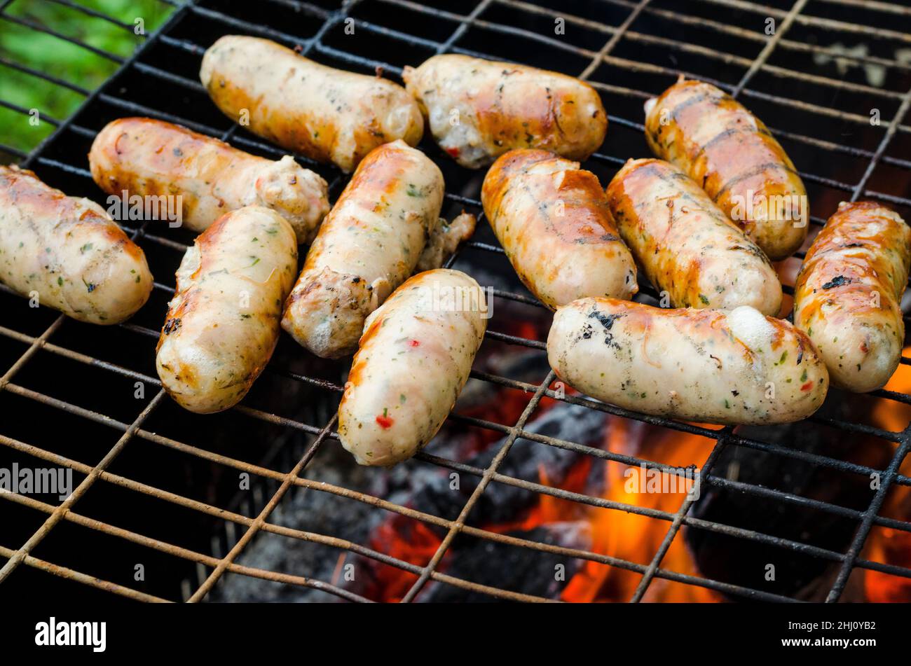 meat fried sausages on a bonfire in the summer Stock Photo - Alamy