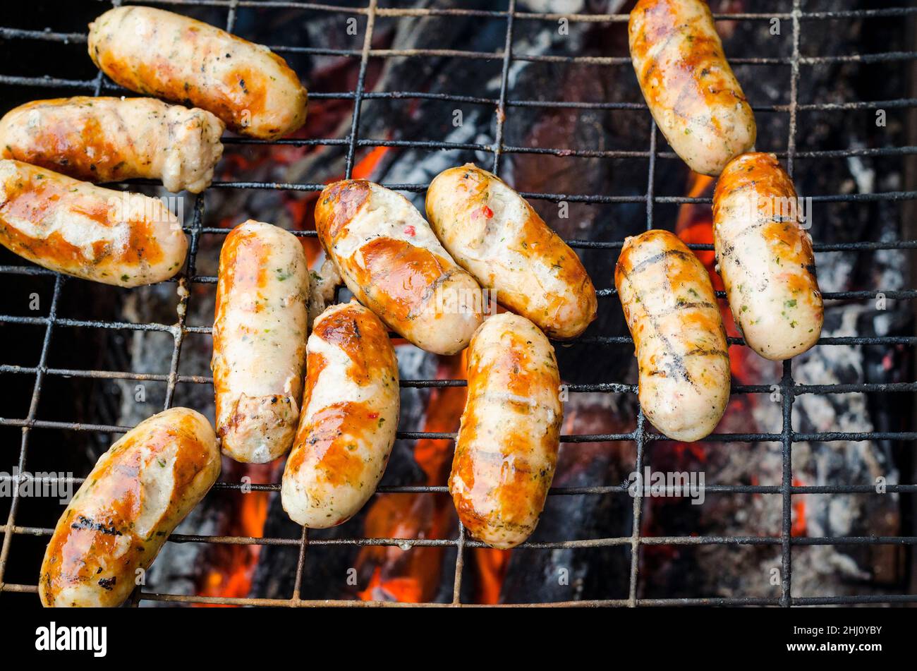 meat fried sausages on a bonfire in the summer Stock Photo - Alamy