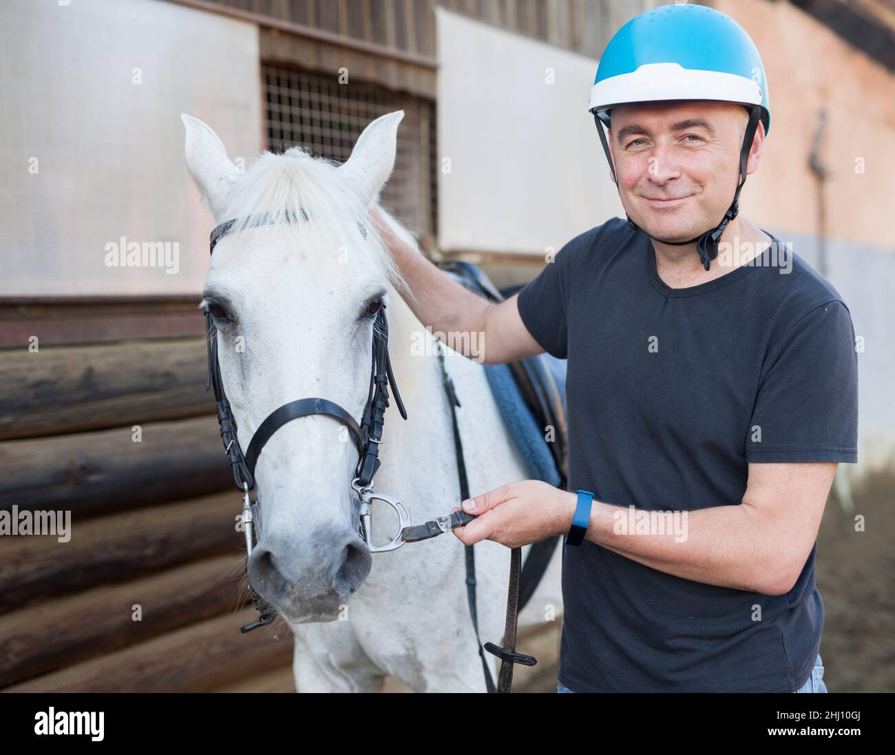 Man in helmet stable hi-res stock photography and images - Alamy