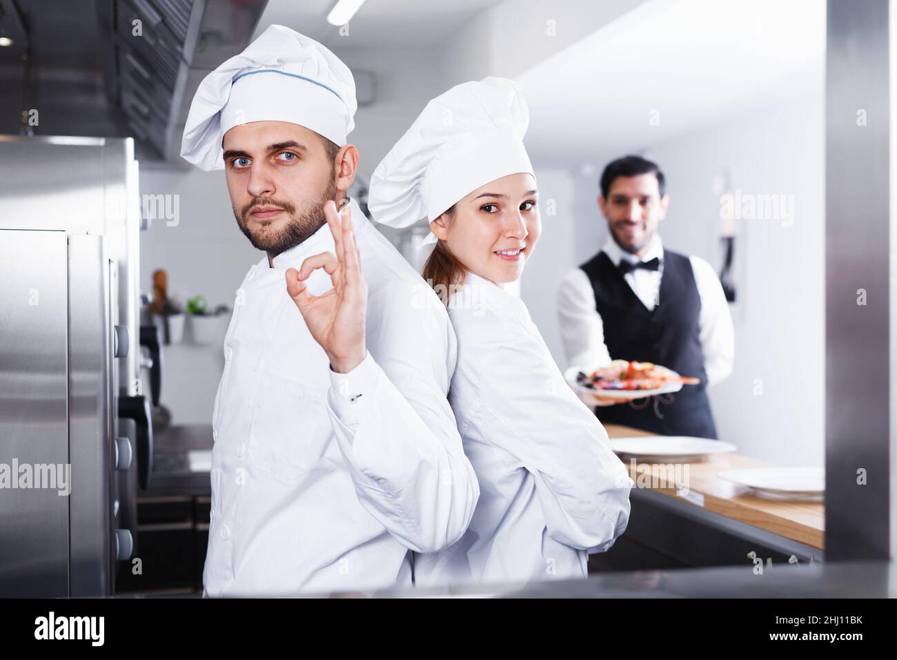 Chefs in fish restaurant kitchen Stock Photo - Alamy