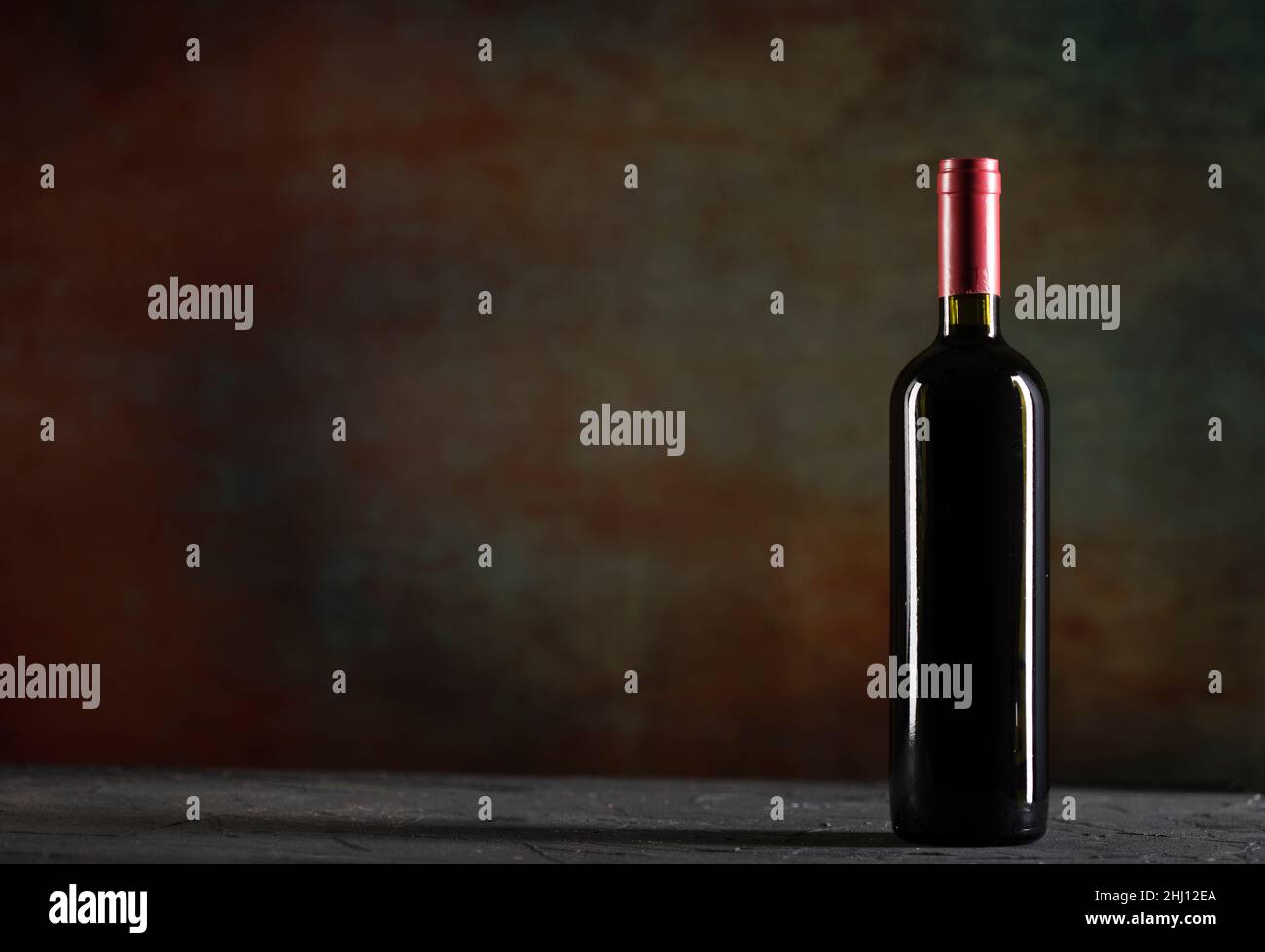 Red Wine buttle on dark background with copy space Stock Photo - Alamy