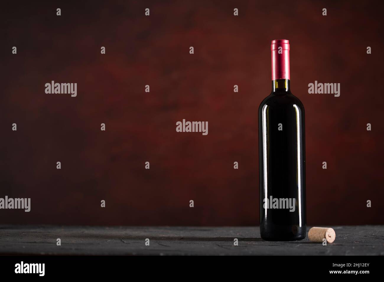 Red Wine buttle on dark background with copy space Stock Photo - Alamy