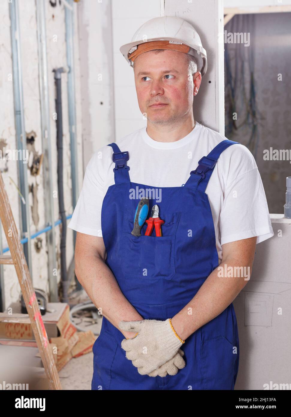 Weary construction worker Stock Photo - Alamy