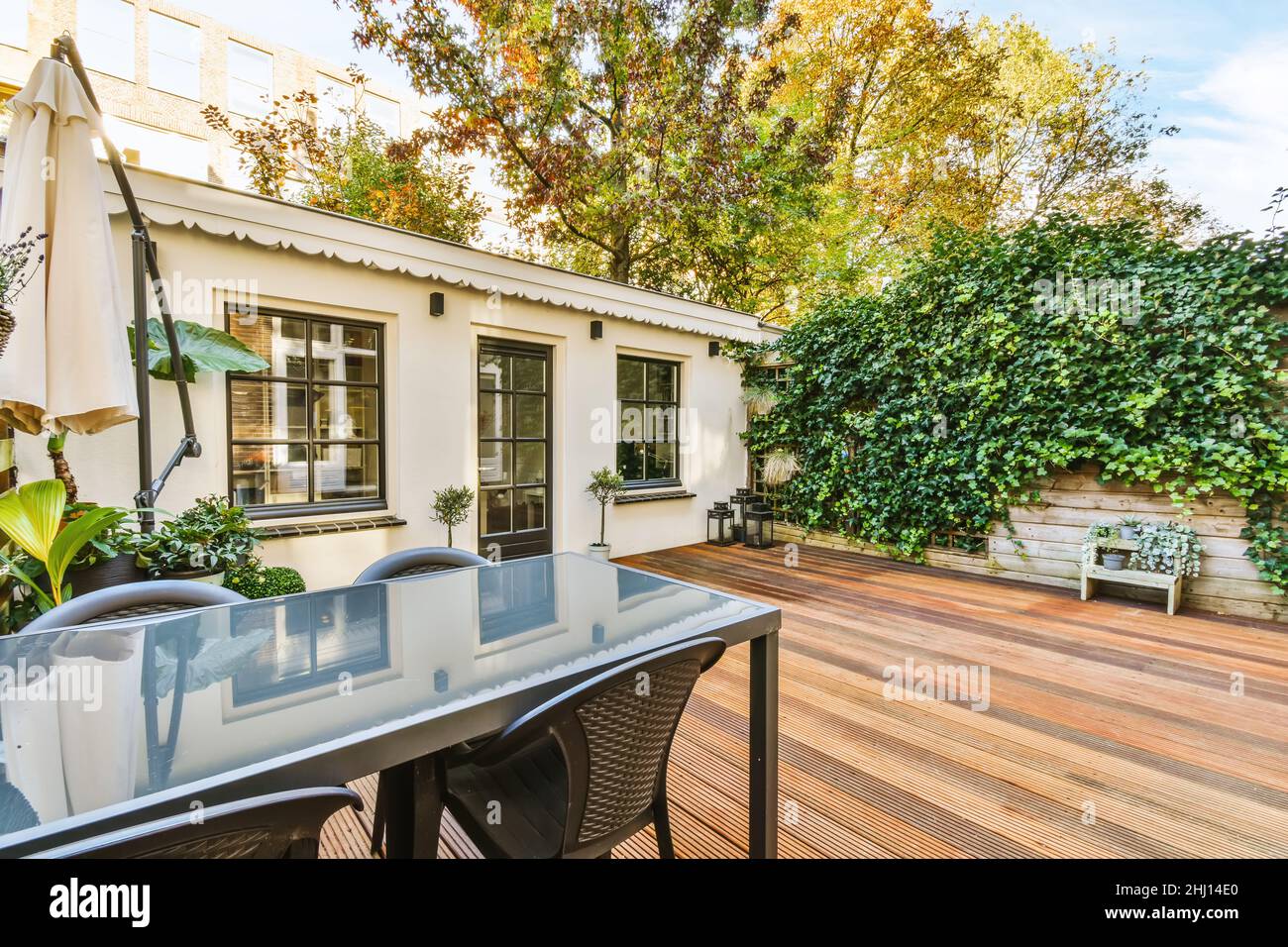 Unique courtyard with wood flooring in a delightful home Stock Photo ...