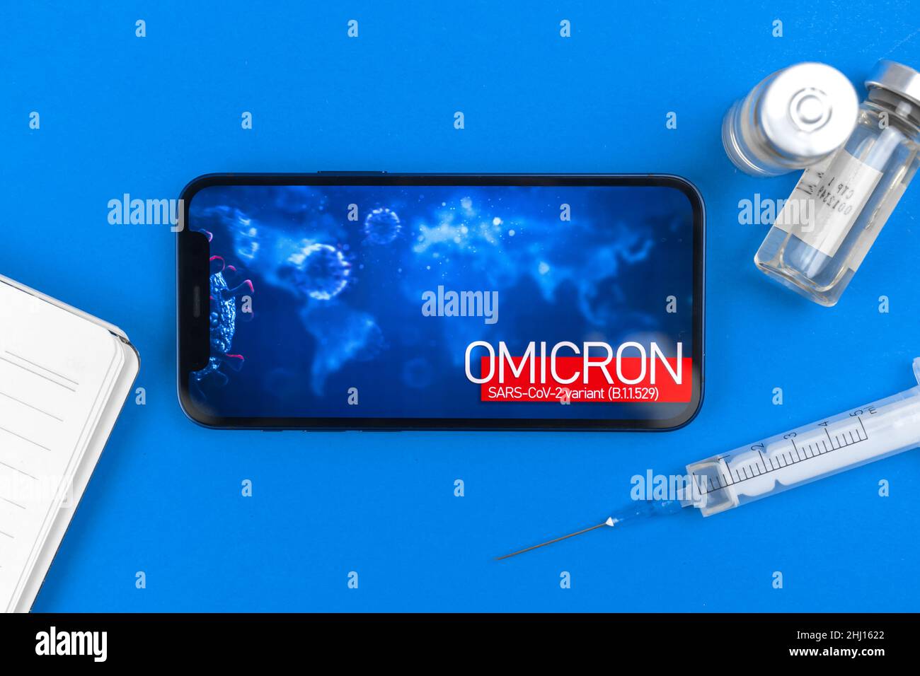 Omicron B.1.1.529 vaccination concept. Medical table with syringe and ...