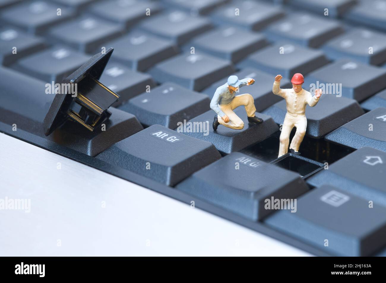 miniature worker on a computer keyboard Stock Photo - Alamy