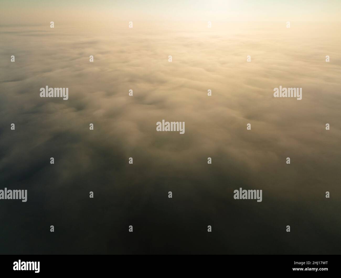 Aerial View over the Clouds in the Morning Sun Stock Photo - Alamy