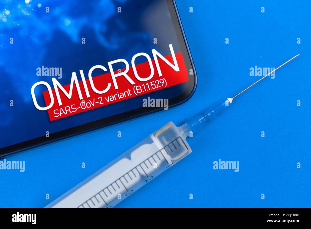 Omicron B.1.1.529 vaccination concept. Medical table with syringe and ...