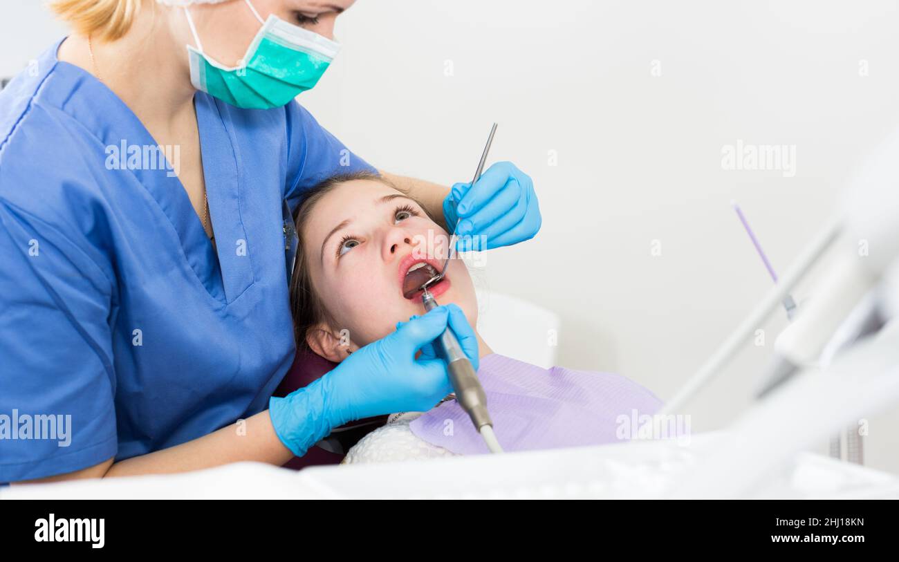 Girl getting dental treatment Stock Photo - Alamy