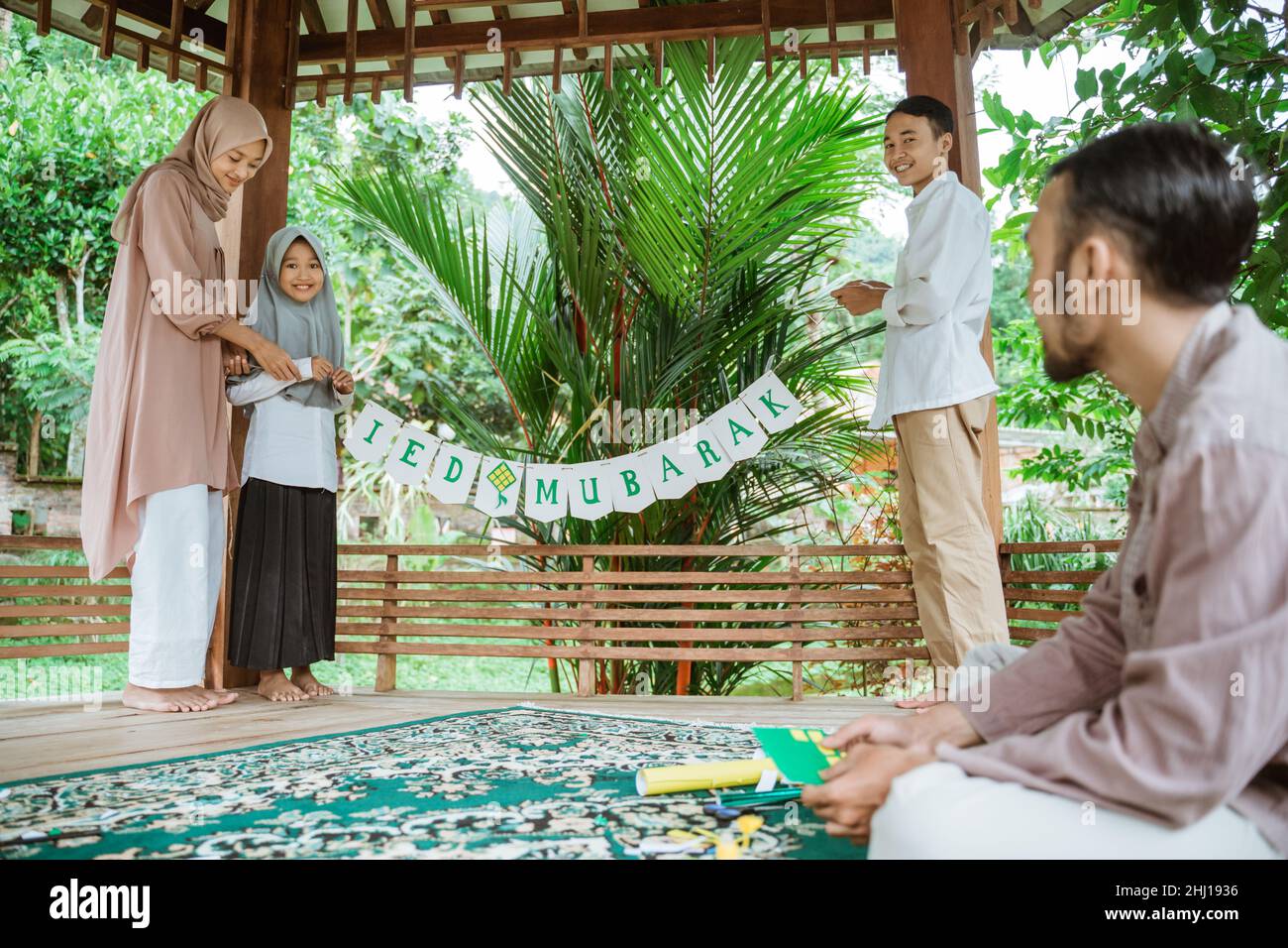 Mother and children make flag chain decorations to celebrate Stock ...