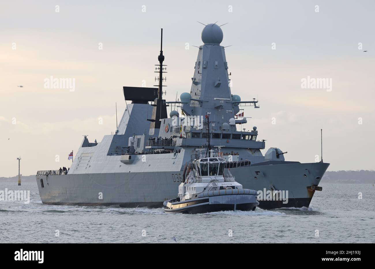 The tug SD TEMPEST escorts HMS DEFENDER into the Naval Base. The ship ...