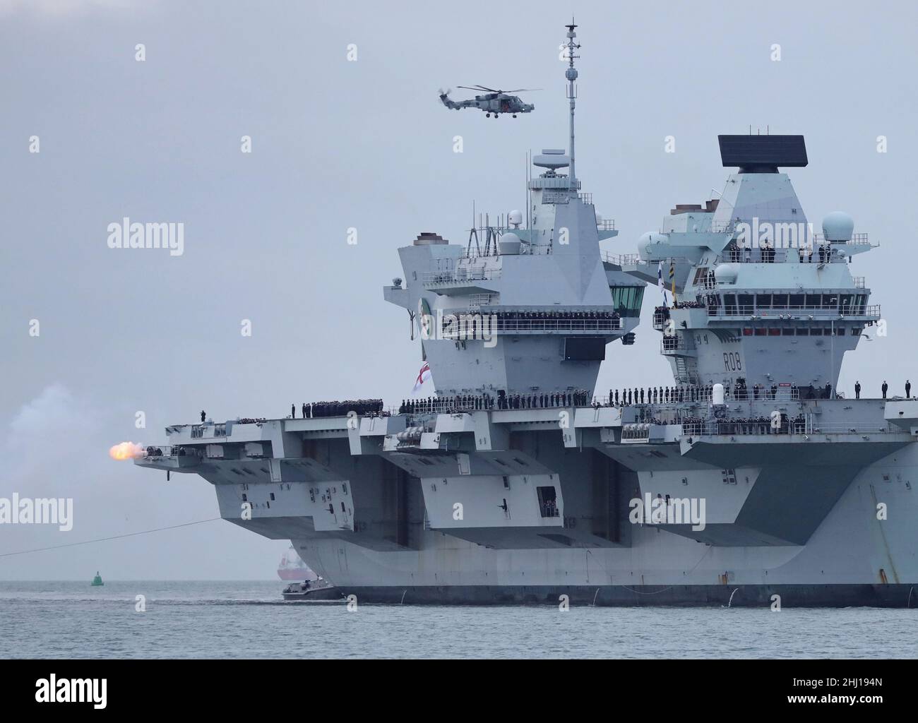HMS QUEEN ELIZABETH firing a 21 gun salute in The Solent as the ship ...