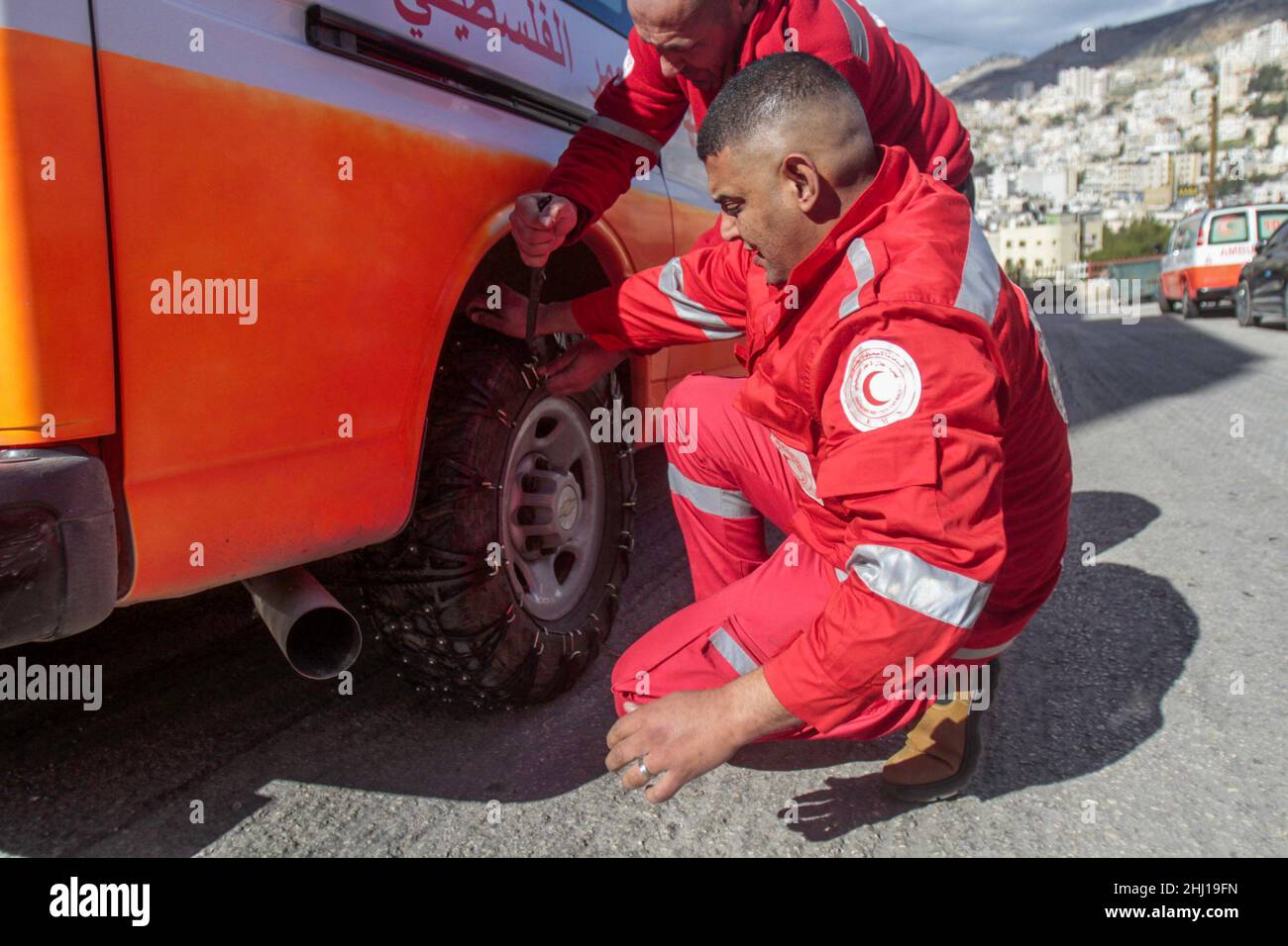 Palestinian ambulance officers put cover for the ambulance tires in ...
