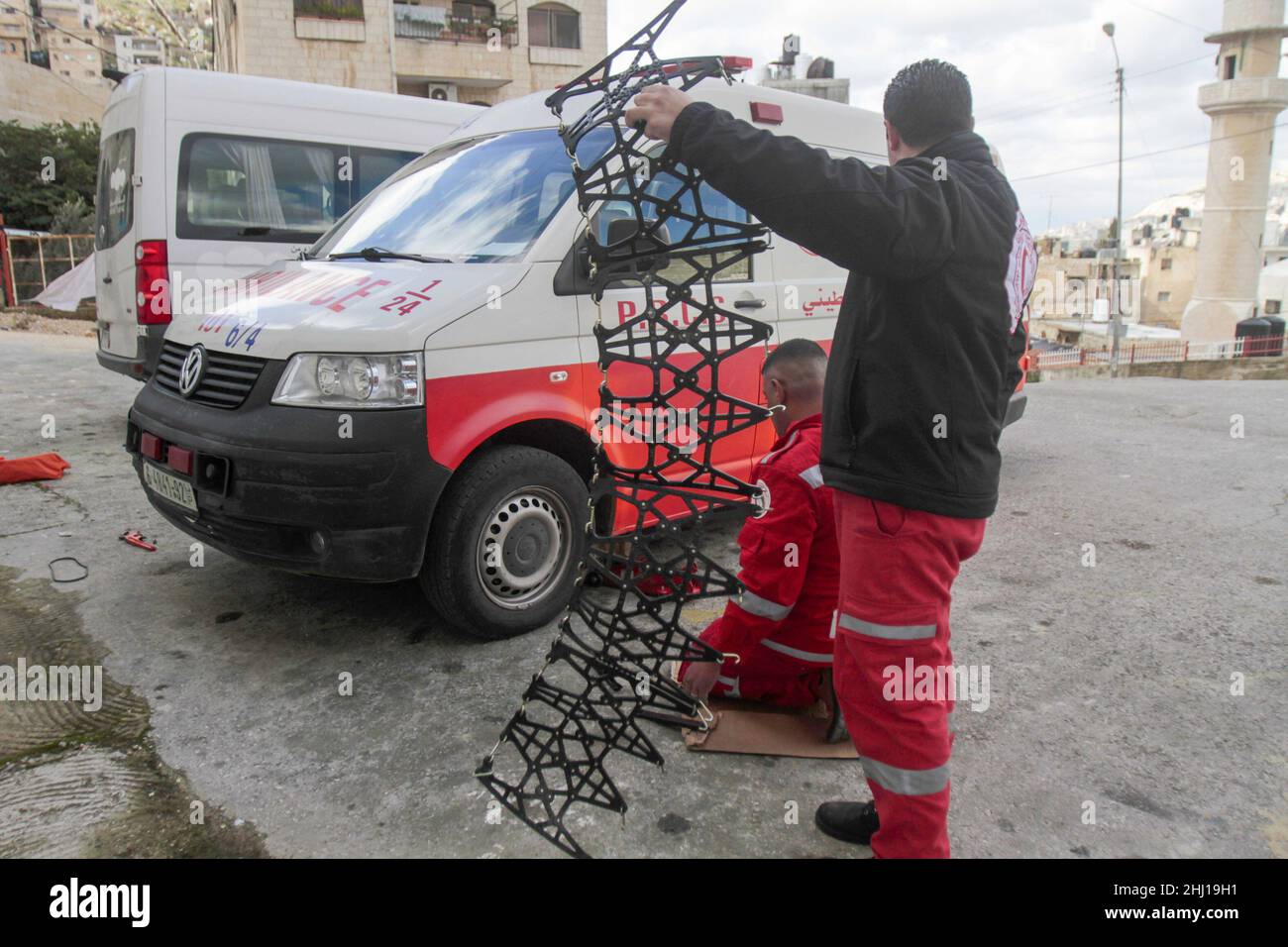 Palestinian ambulance officers put cover for the ambulance tires in ...