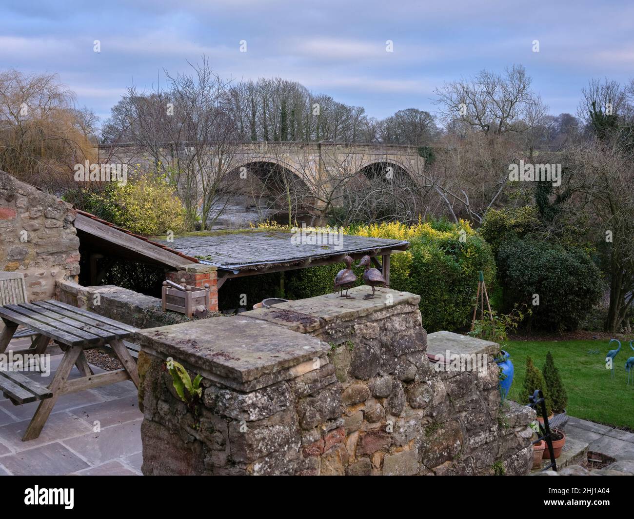 View of the bridge over the River Ure across a private garden, West ...