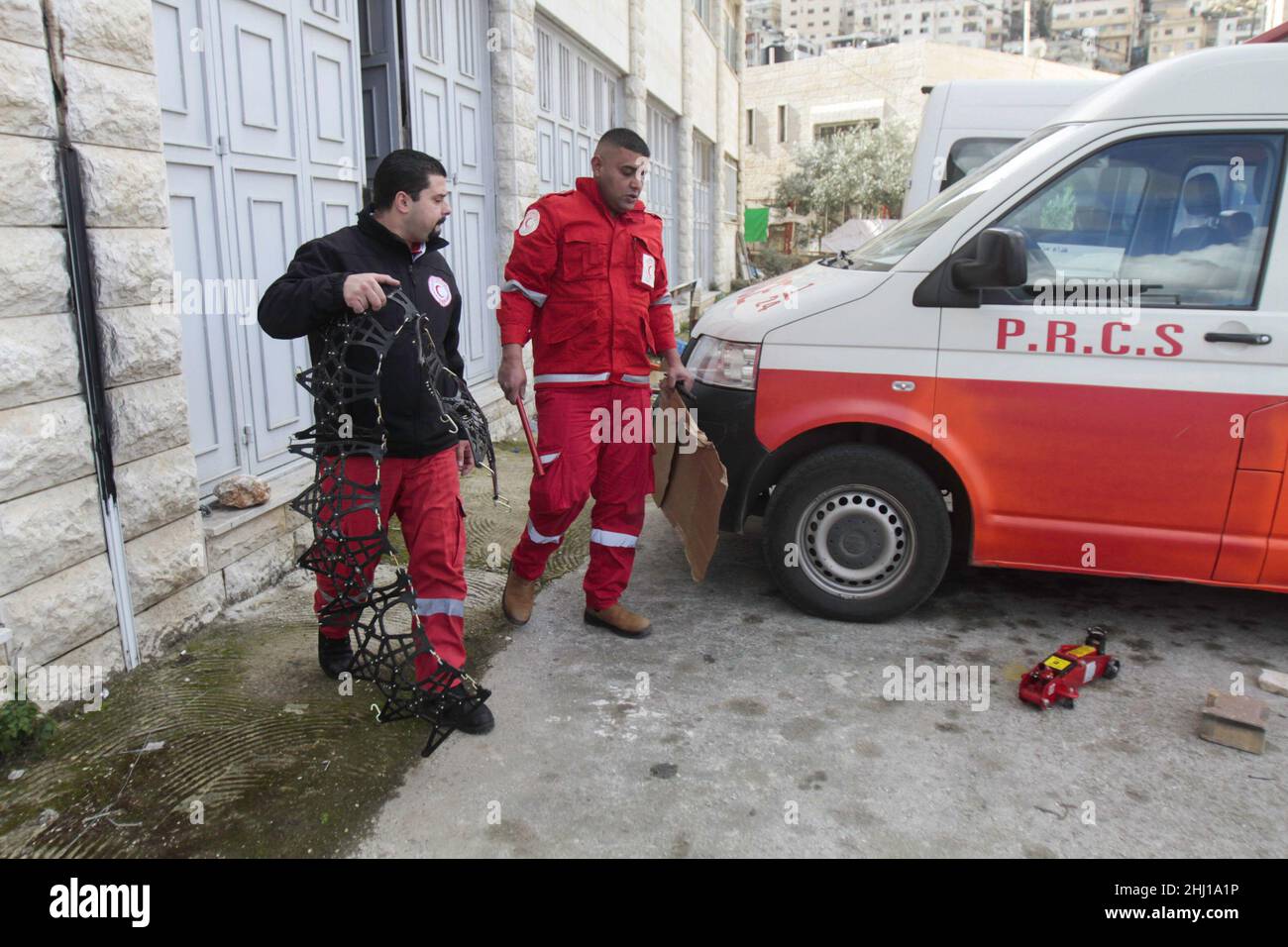 Palestinian ambulance officers put cover for the ambulance tires in ...