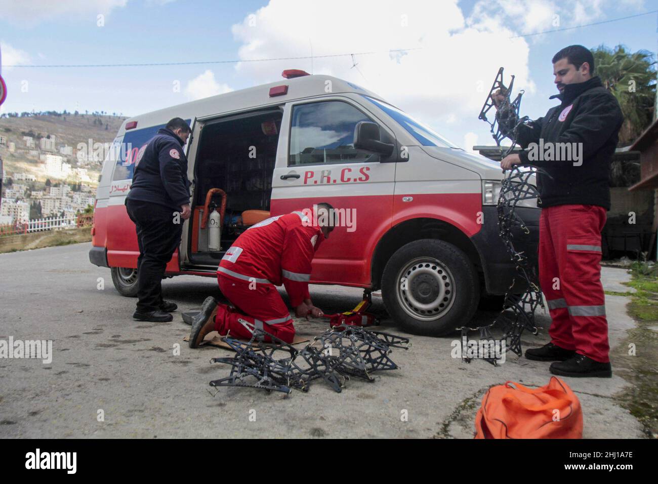 Palestinian ambulance officers put cover for the ambulance tires in ...