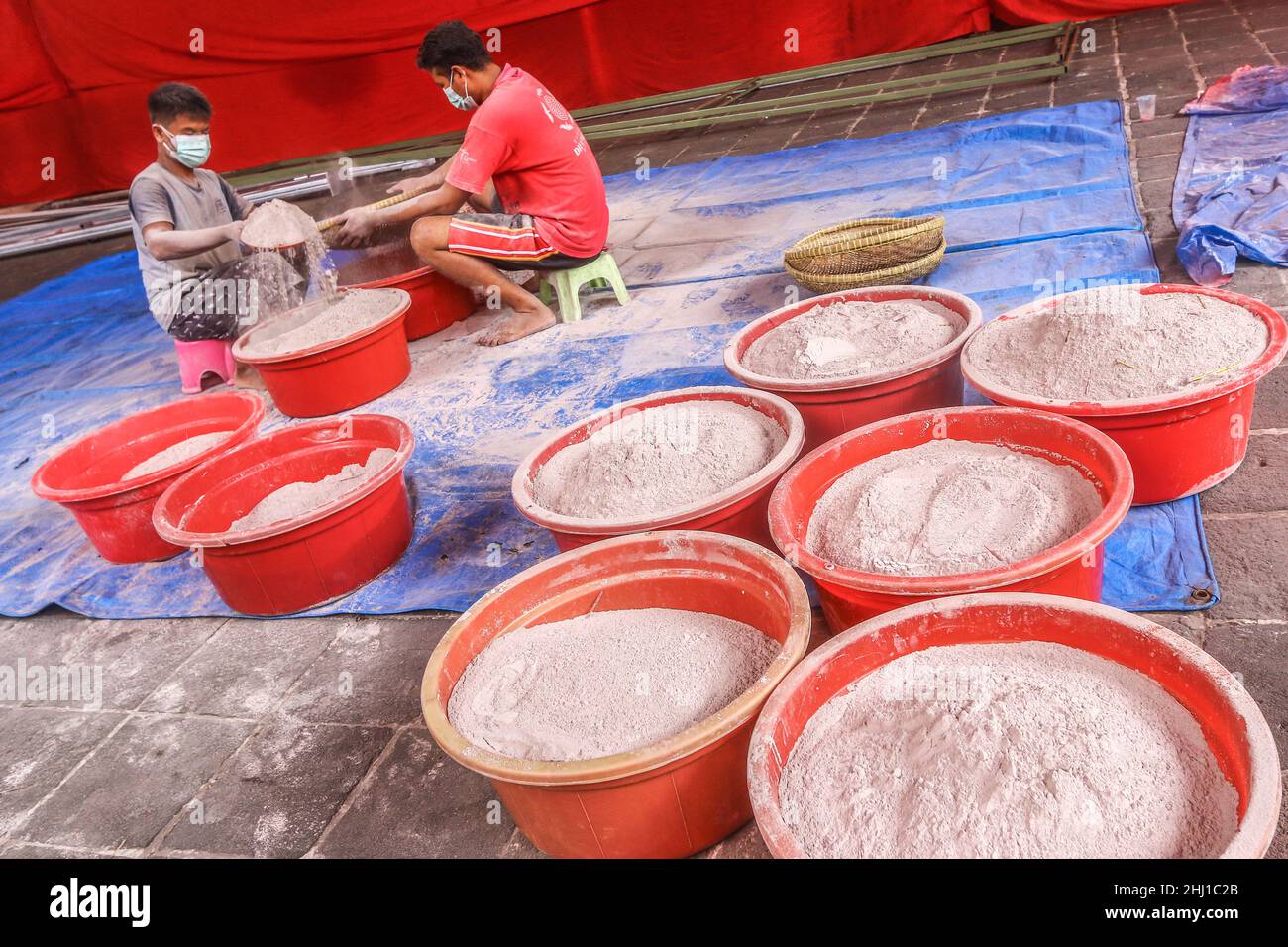 Workers lift ashes during ash sifting ritual upcoming of the Lunar New ...