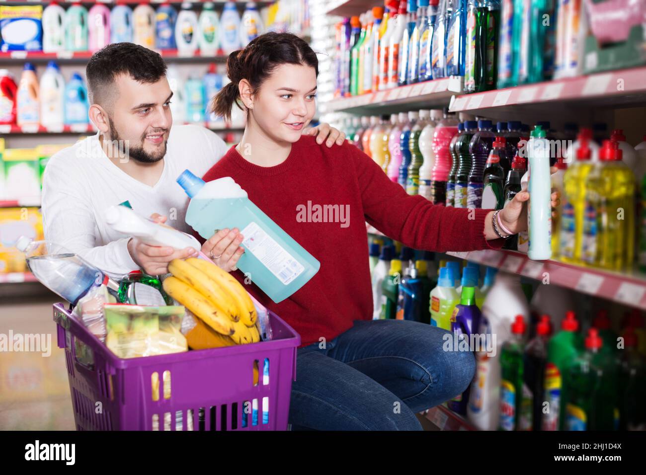 Couple choose some detergents Stock Photo - Alamy