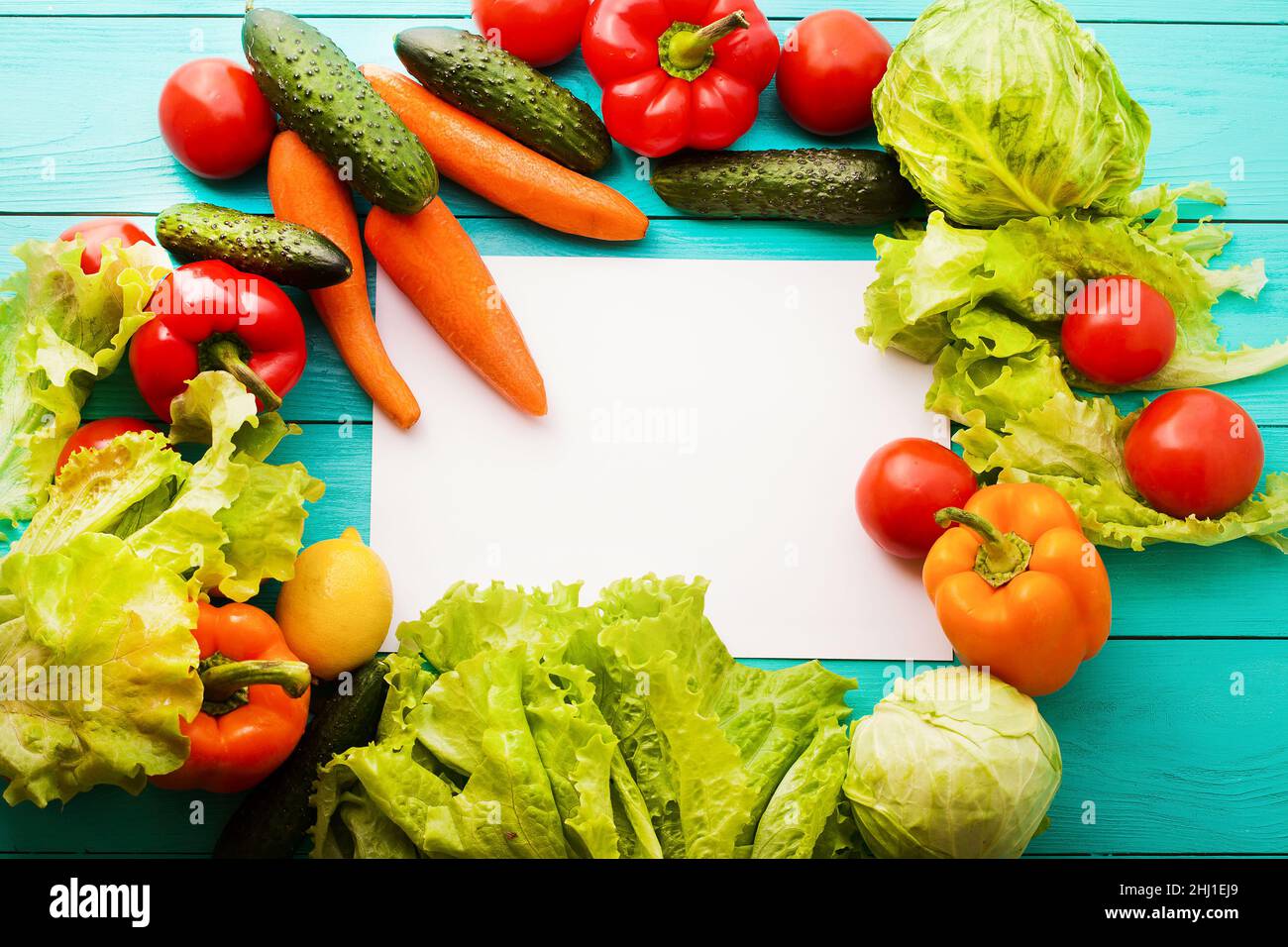Different vegetables on kitchen table with recipe list and copy space ...