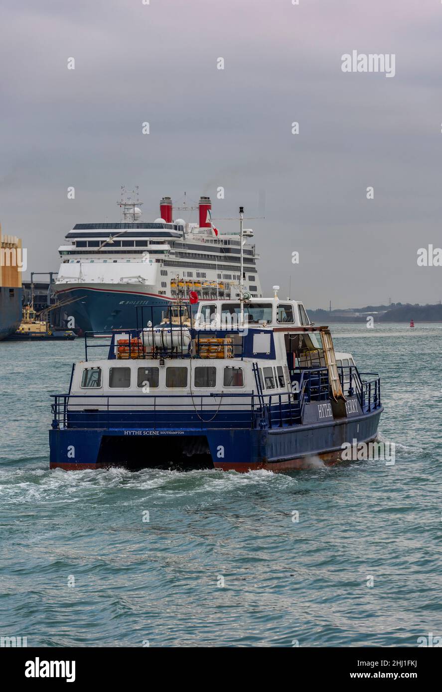 hythe ferry crossing southampton water past large cruise ships and ...