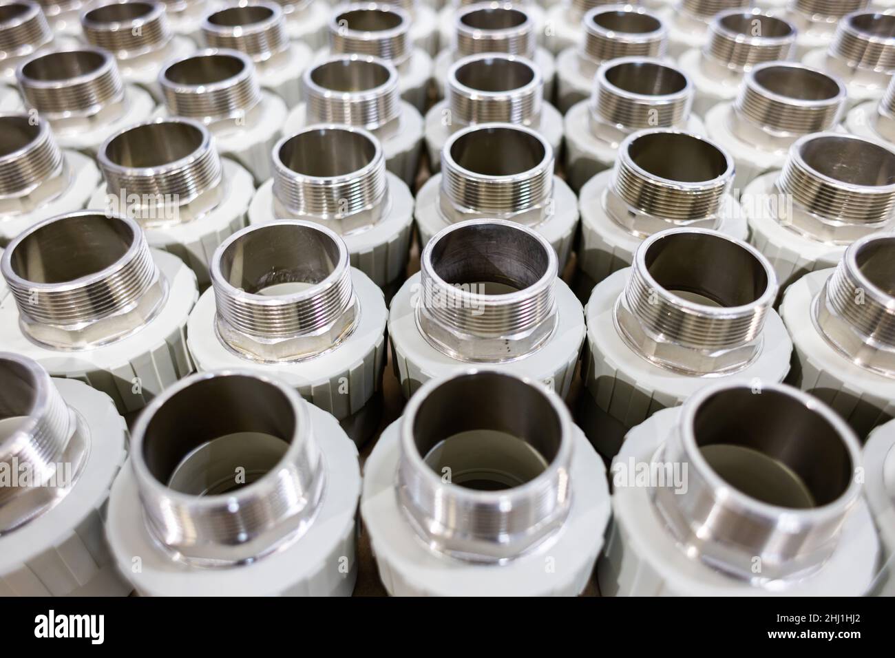 many metal pipe couplings in a pipe factory Stock Photo - Alamy