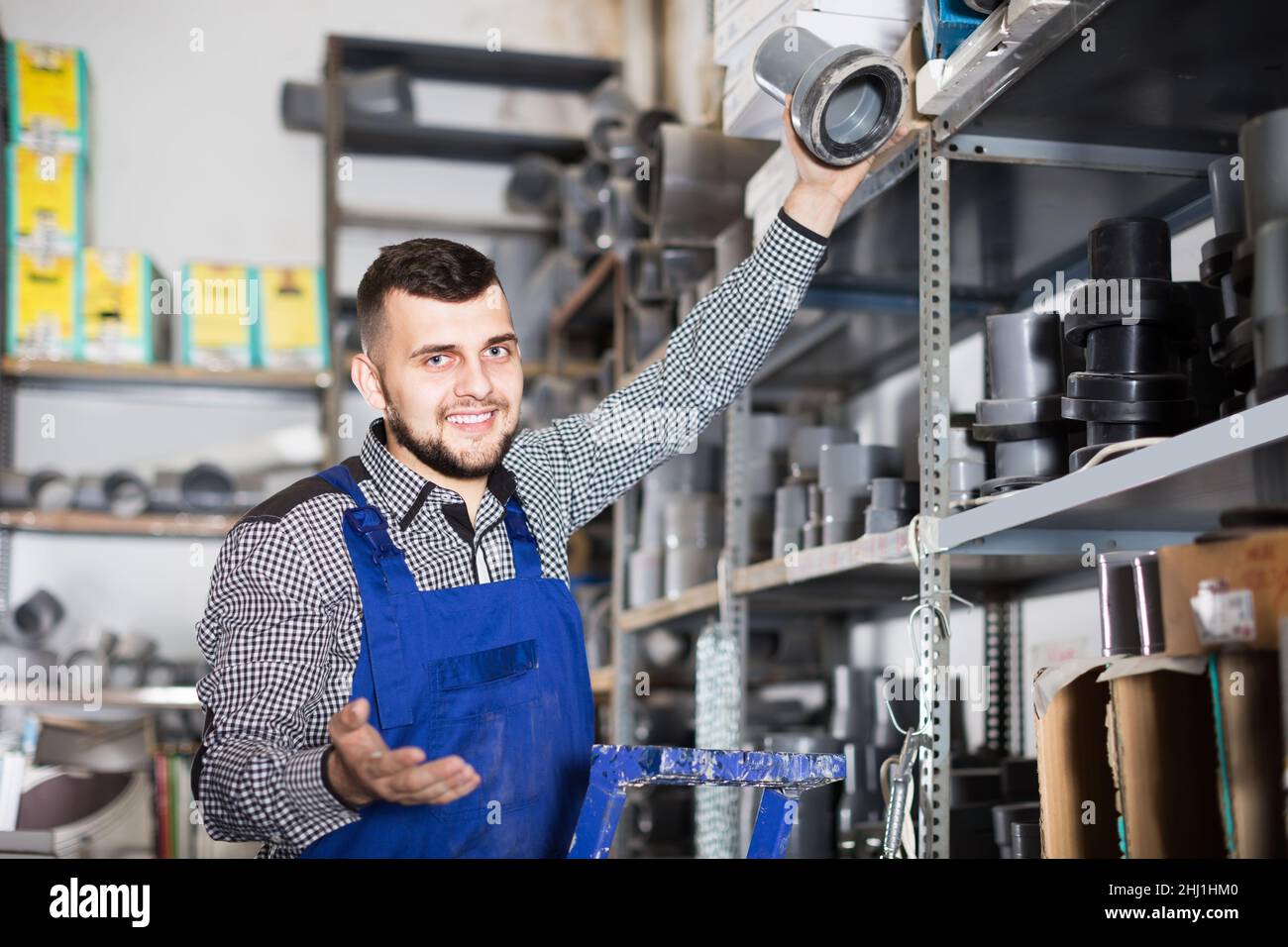 Worker demonstrates the choice of plastic pipes Stock Photo - Alamy