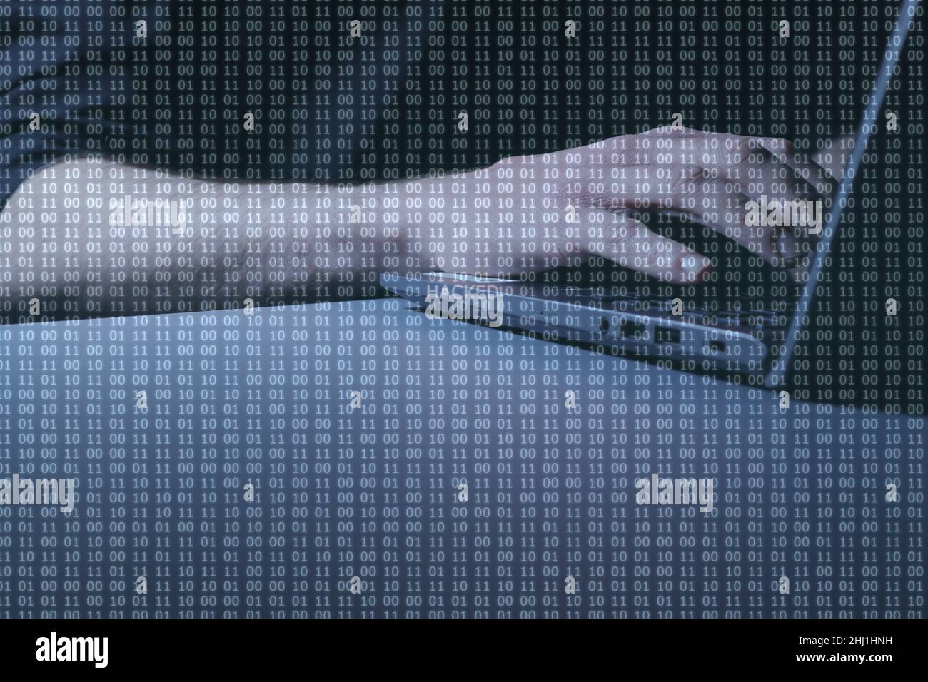 Hacked - Hands at computer with binary code overlay with the word ...