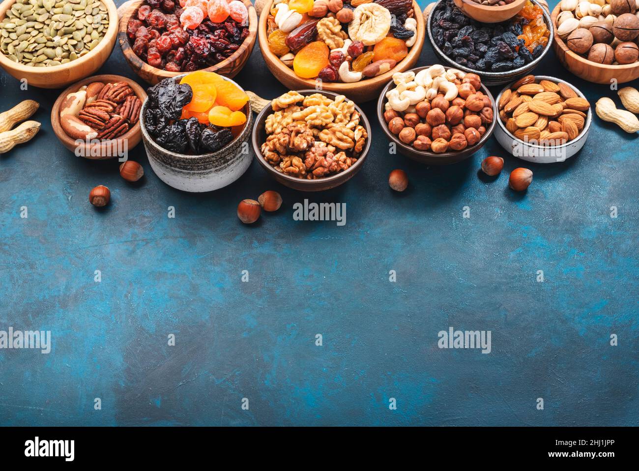 Nuts and dried fruits in assortment. Dry apricots, figs, raisins, walnuts, almonds and other ...