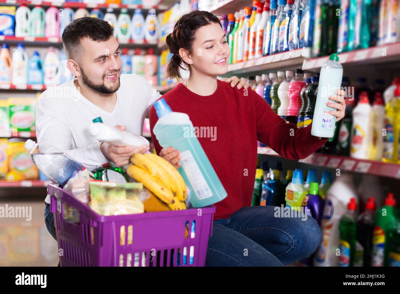Couple choose some detergents Stock Photo - Alamy