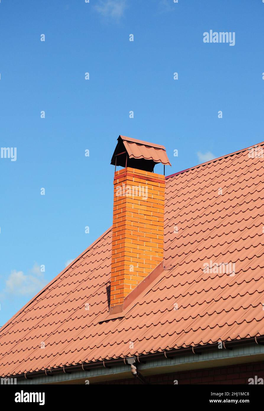 Red Metal Roof with Brick Chimney. Metal Roofing Construction Stock ...