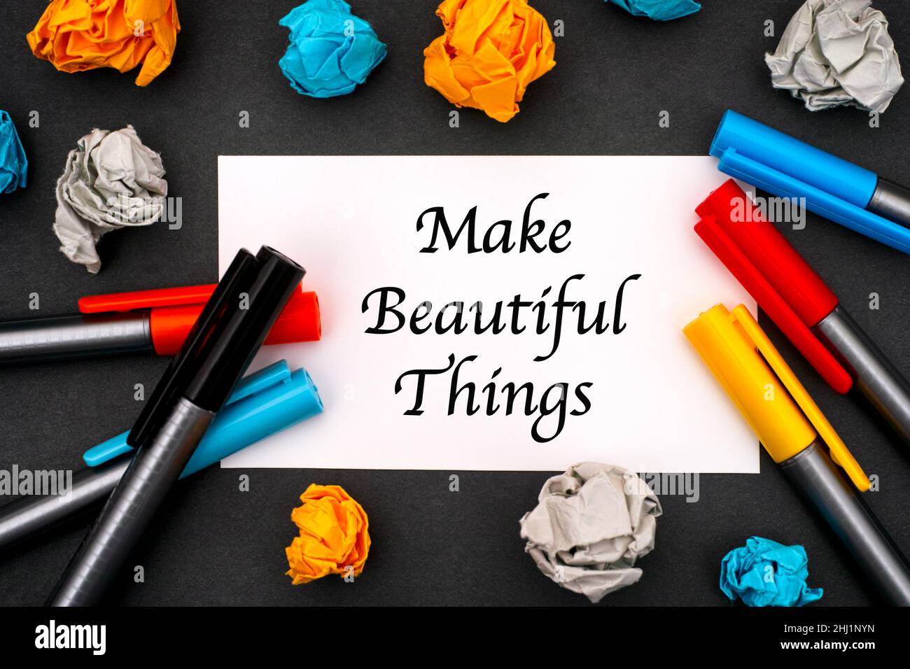 White paper with words Make Beautiful Things, colour pens and crumpled ...