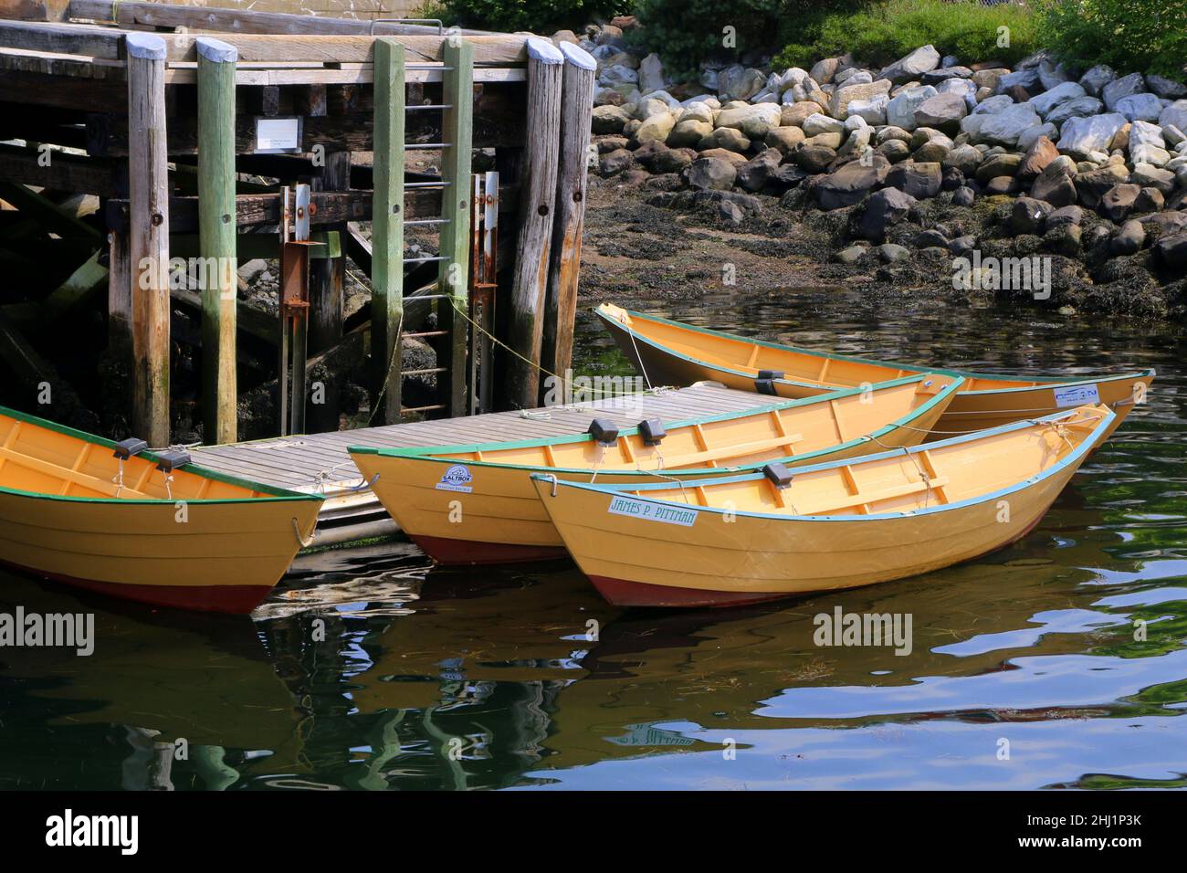 The yellow rowboats are tied up at the wharf Stock Photo - Alamy