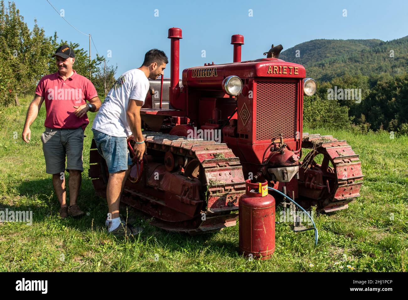 Italian boys start the engine of a Bubba Ariete, hot-headed tractor ...