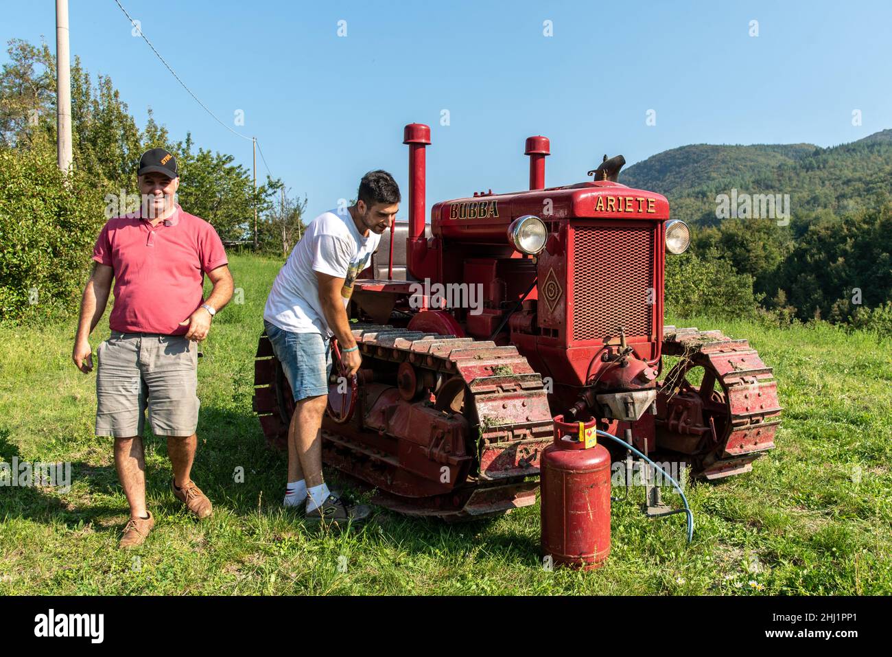 Italian boys start the engine of a Bubba Ariete, hot-headed tractor ...