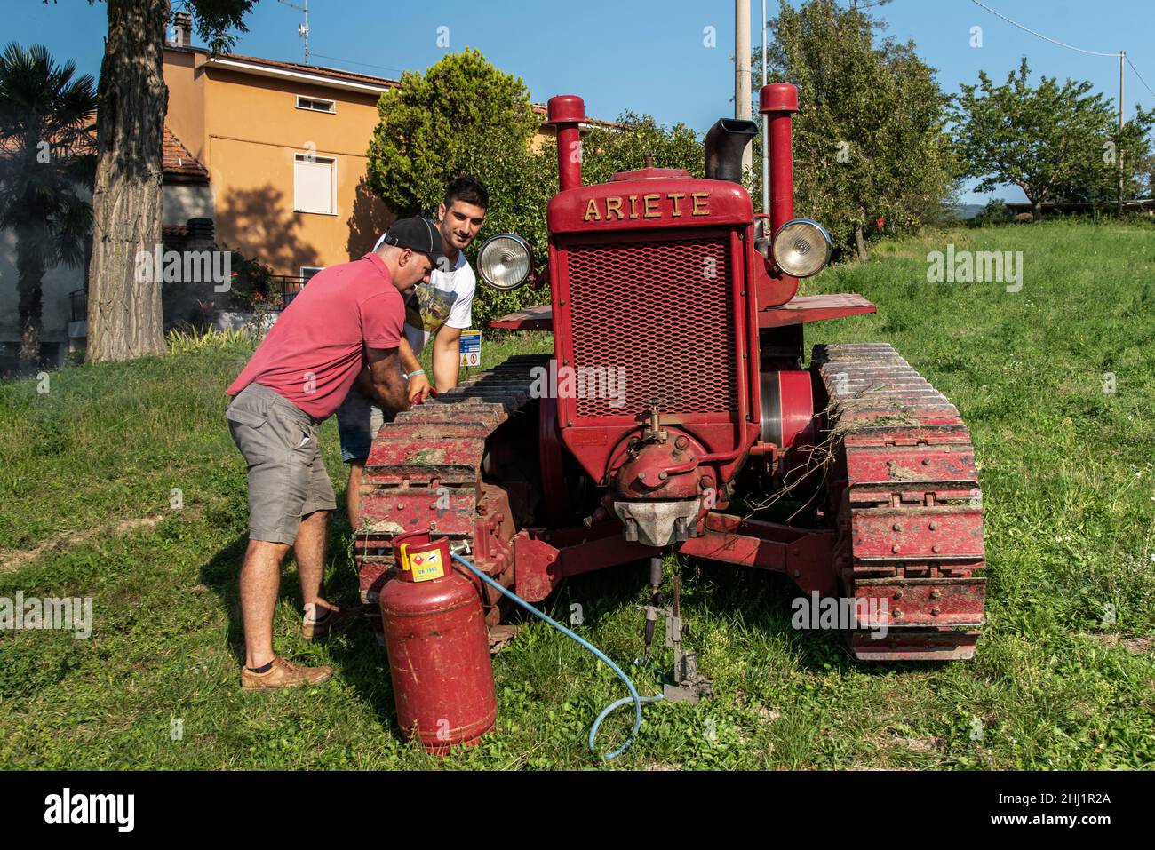 Italian boys start the engine of a Bubba Ariete, hot-headed tractor ...