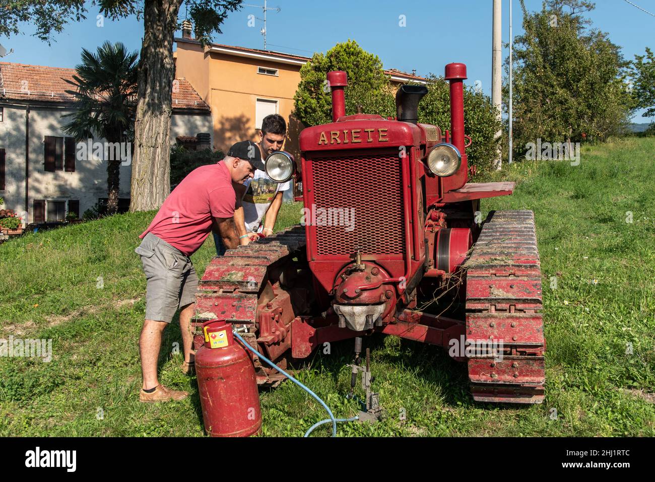 Italian boys start the engine of a Bubba Ariete, hot-headed tractor ...