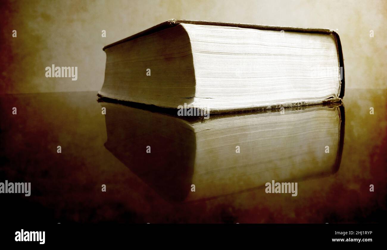 A large single book sitting on a desk antique for learning and study ...