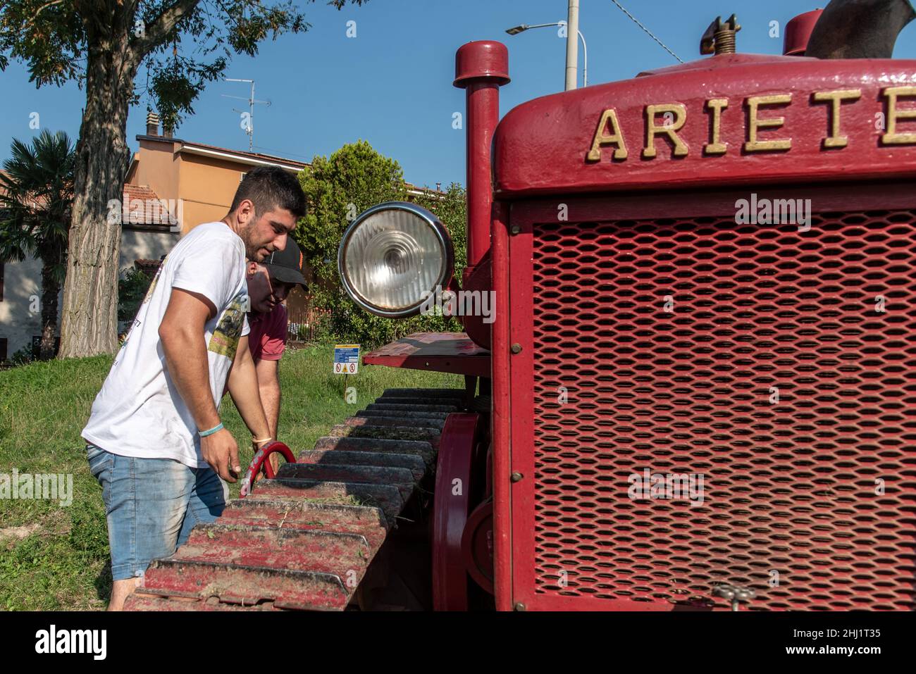 Italian boys start the engine of a Bubba Ariete, hot-headed tractor ...