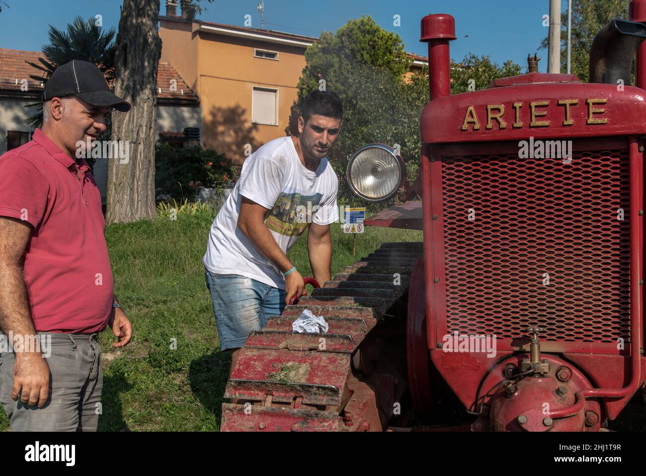 Italian boys start the engine of a Bubba Ariete, hot-headed tractor ...