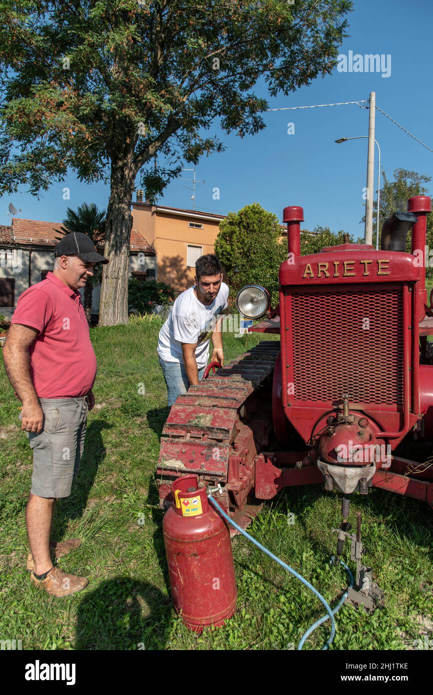 Italian boys start the engine of a Bubba Ariete, hot-headed tractor ...