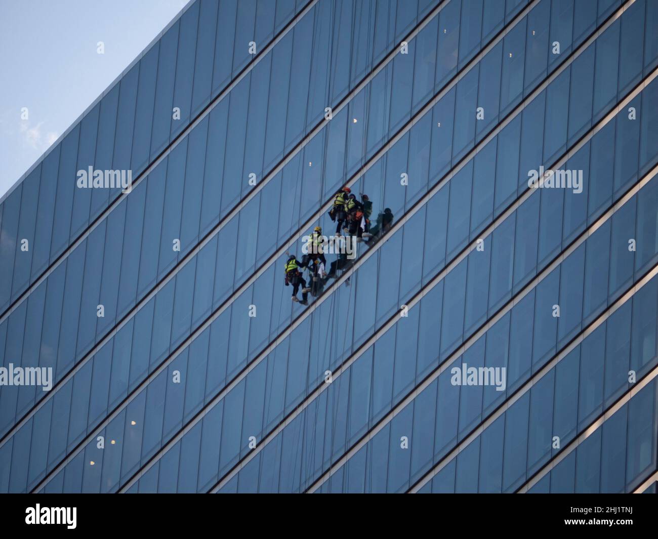 Window cleaners abseiling while cleaning skyscraper in central London ...