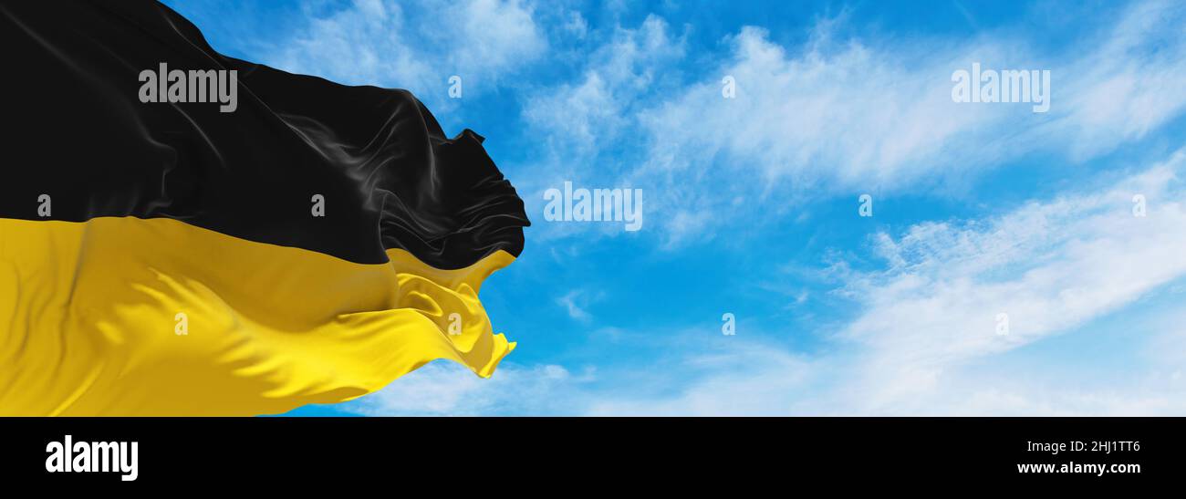flag of Munster Westfalen at cloudy sky background on sunset, panoramic ...