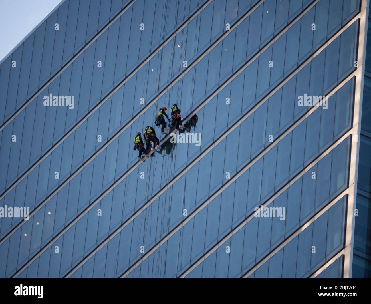 Window cleaners abseiling while cleaning skyscraper in central London ...