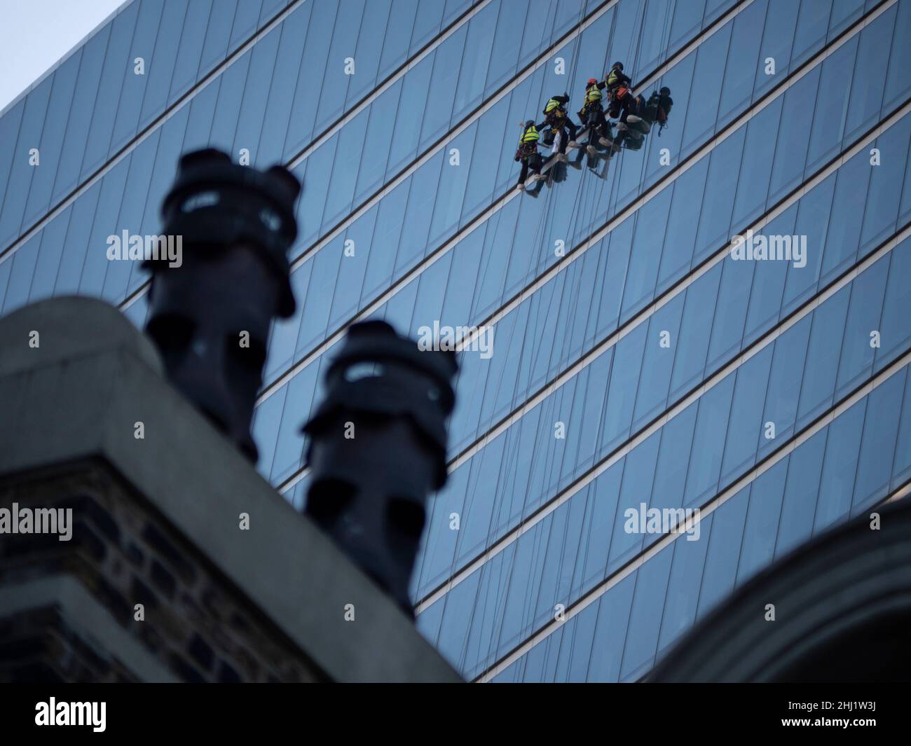 Window cleaners abseiling while cleaning skyscraper in central London ...